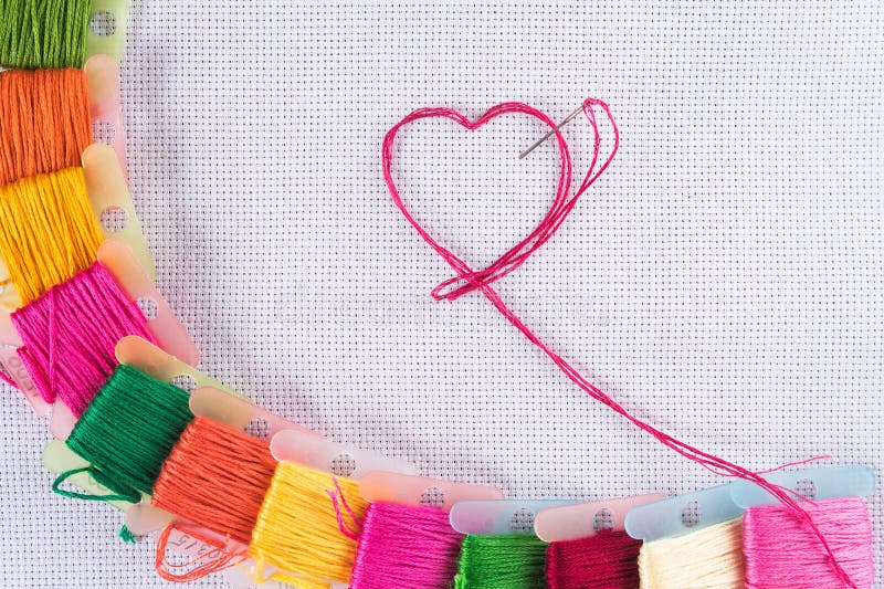 Colored Thread for Embroidery on White Canvas, a Needle with Red Thread ...