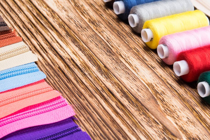 Colored Thread Laid Out in Front of Lightning on a Wooden Table Stock ...