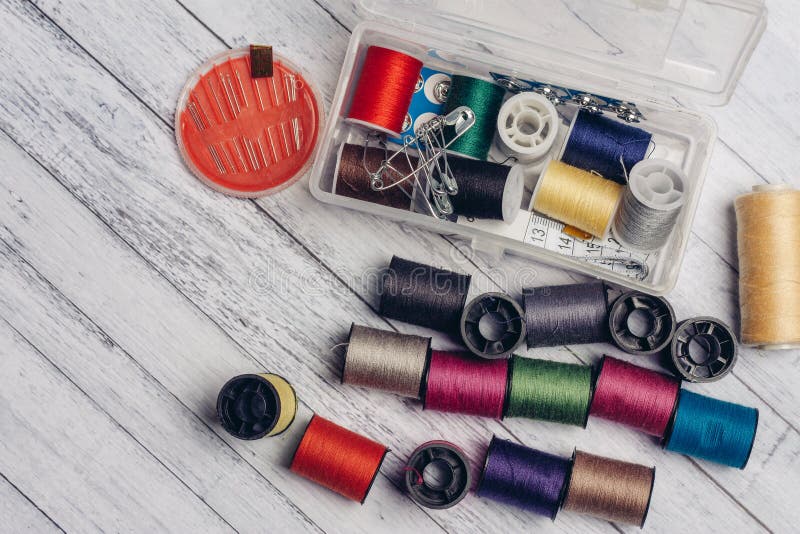 Colored Threads in a Scattered Position on a Wooden Table and Sewing ...