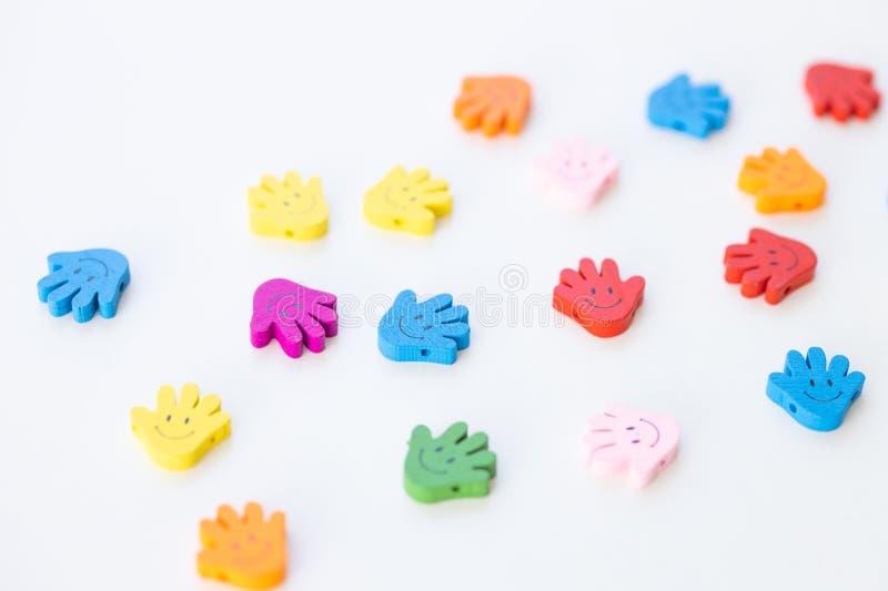 Colored Wooden Figures in the Form Hand with Smiles on a White ...