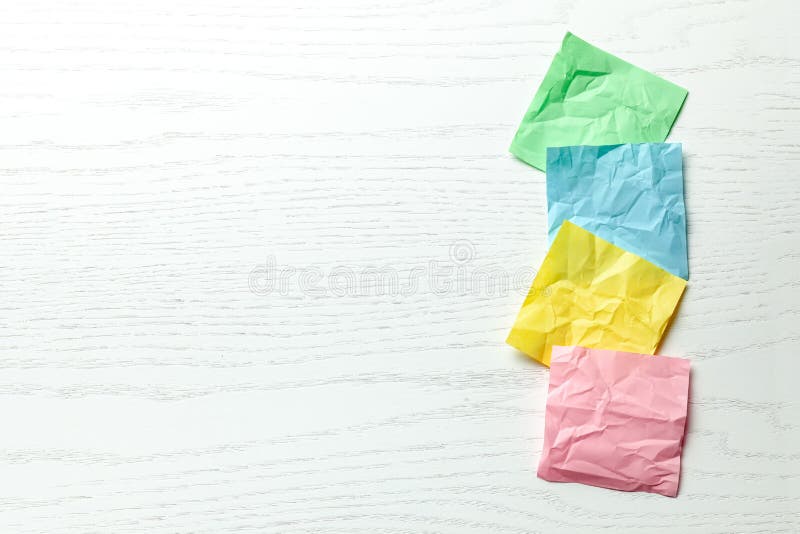 Colored Wrinkled Note Paper on White Wooden Table. Copy Space for Text ...