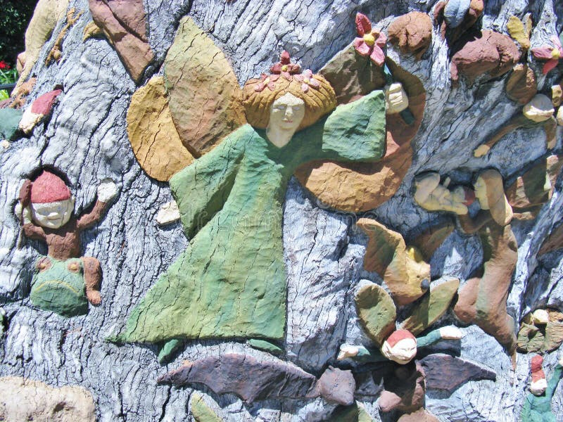 A Colorful Angel Carved in a Tree Stock Photo - Image of angel, fairy ...