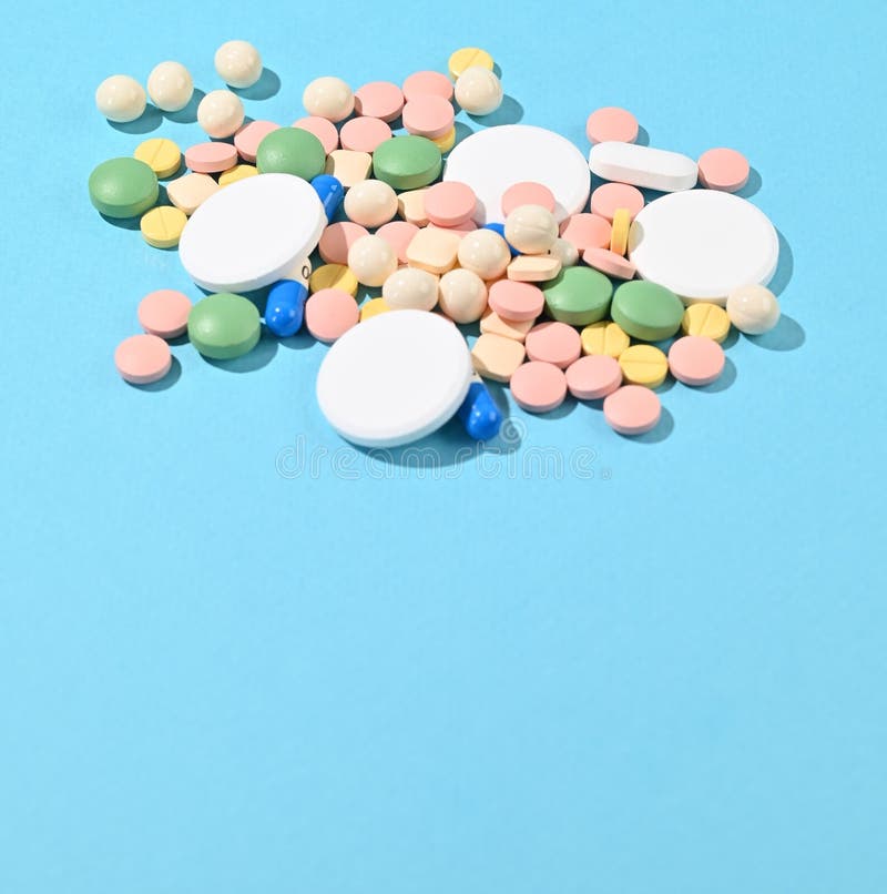 Colorful Assortment of Various Antibiotic Pills and Tablets on a Blue ...