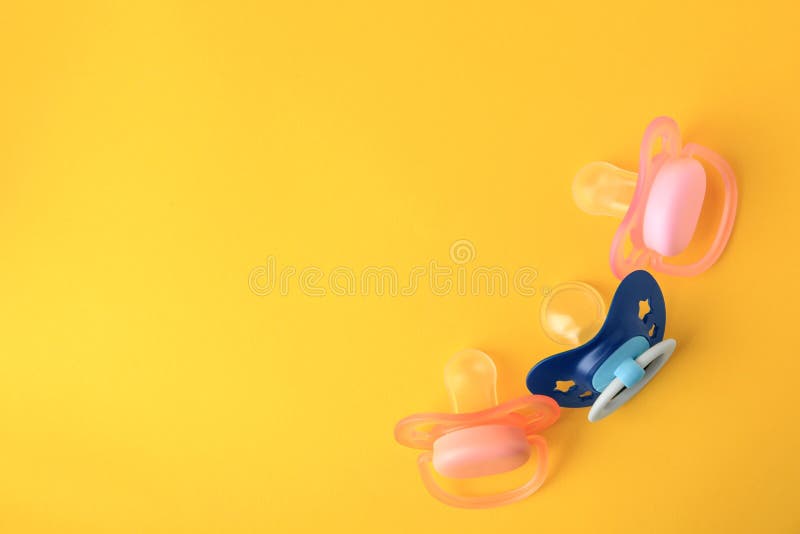 Colorful Baby Pacifiers on Orange Background, Flat Lay. Space for Text ...