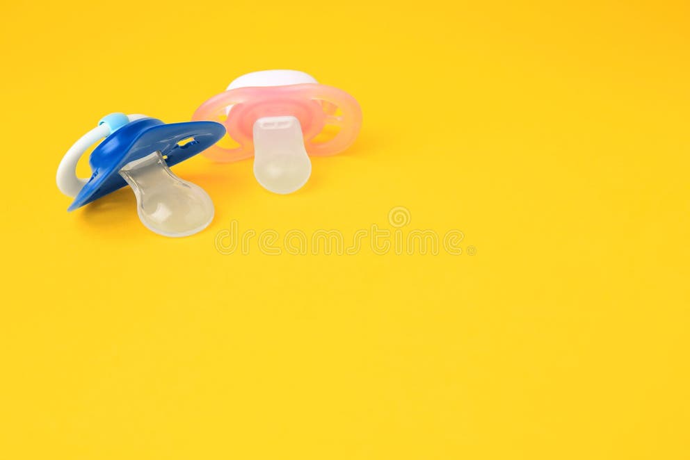 Colorful Baby Pacifiers on Orange Background. Space for Text Stock ...