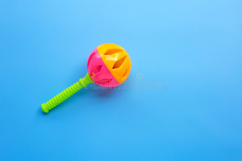Colorful Baby Rattle On Blue Background Stock Image - Image of still ...
