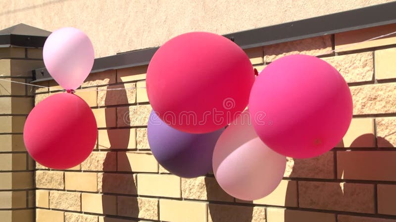 Colorful Balloons, in the Wind Near a Brick Wall Stock Video - Video of ...