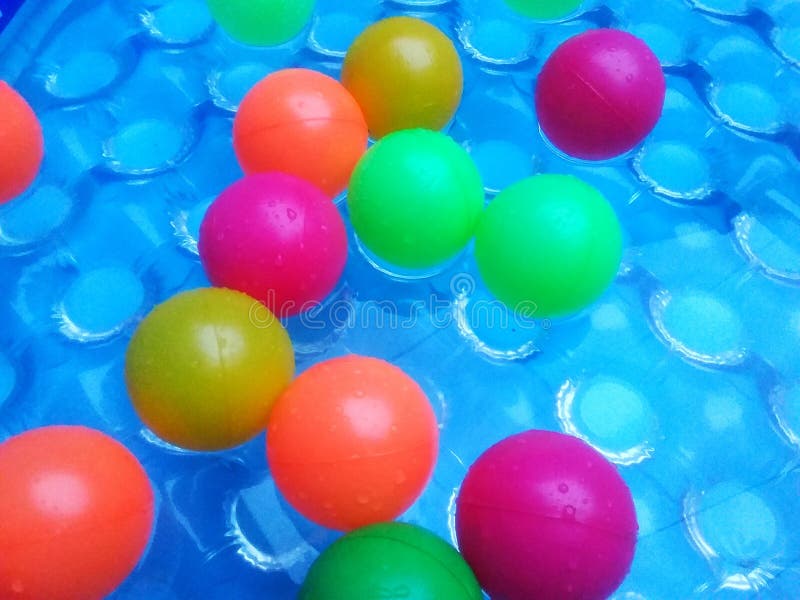 Colorful Balls Floating in the Pool Water Stock Photo - Image of ...