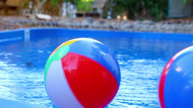Colorful Beach Ball Thrown into the Water in the Pool Stock Footage ...