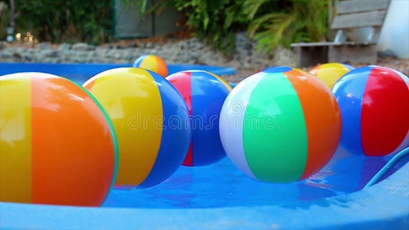 Colorful Beach Balls Floating in Pool in Slow Motion Stock Video ...