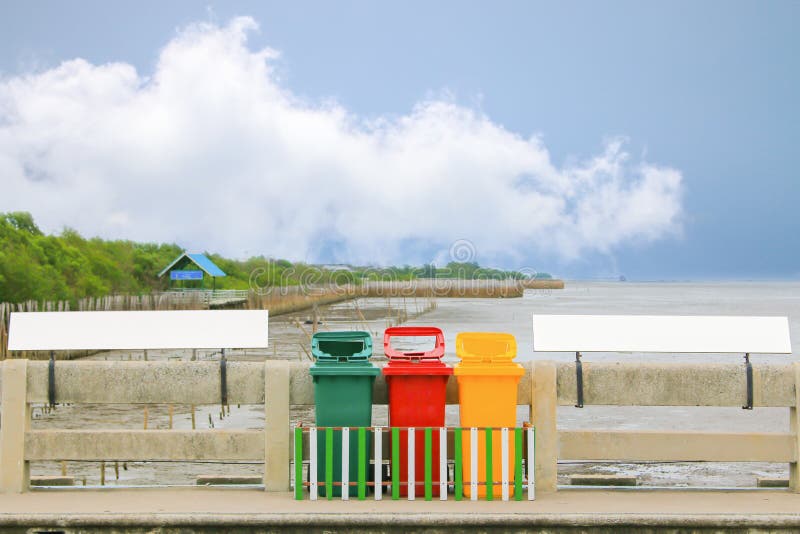 Colorful Bin between Signage on Blue Sky Background Stock Image - Image ...