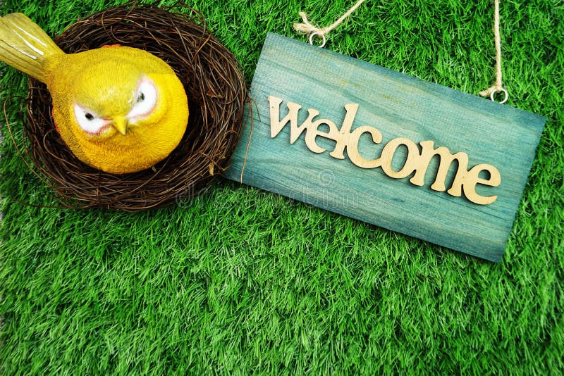 Colorful Bird Statue with Nest and Welcome Sign on Artificial Green ...