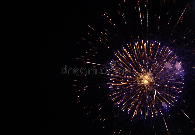 Colorful Blue and Yellow Fireworks on a Night Background with Space on ...