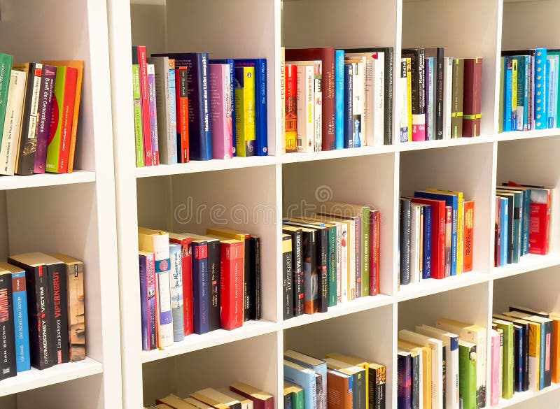 Colorful Bookshelf with Assorted Books in Modern Library Setting ...