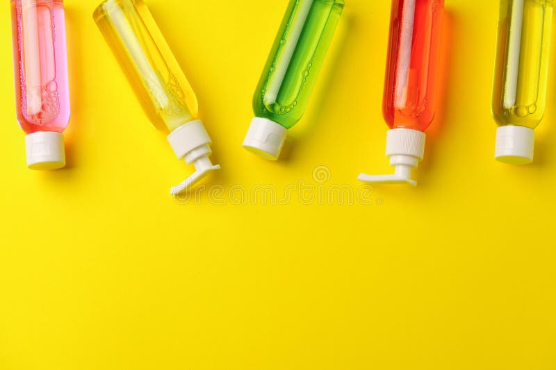 Colorful Bottles of Liquid Soap on Yellow Background Stock Image ...
