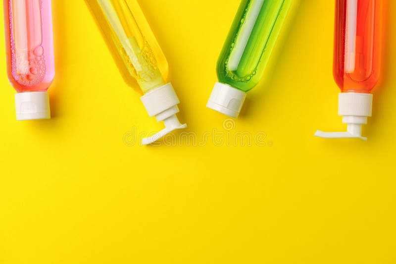 Colorful Bottles of Liquid Soap on Yellow Background Stock Image ...