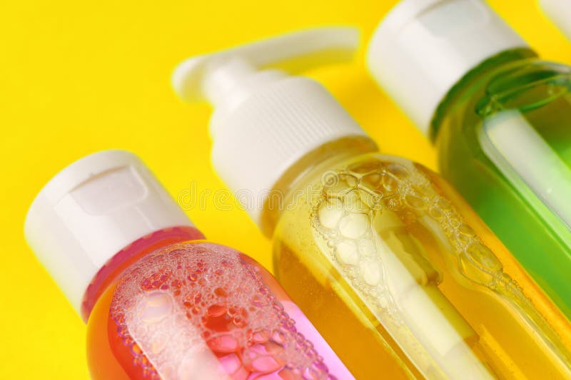 Colorful Bottles of Liquid Soap on Yellow Background Stock Image ...