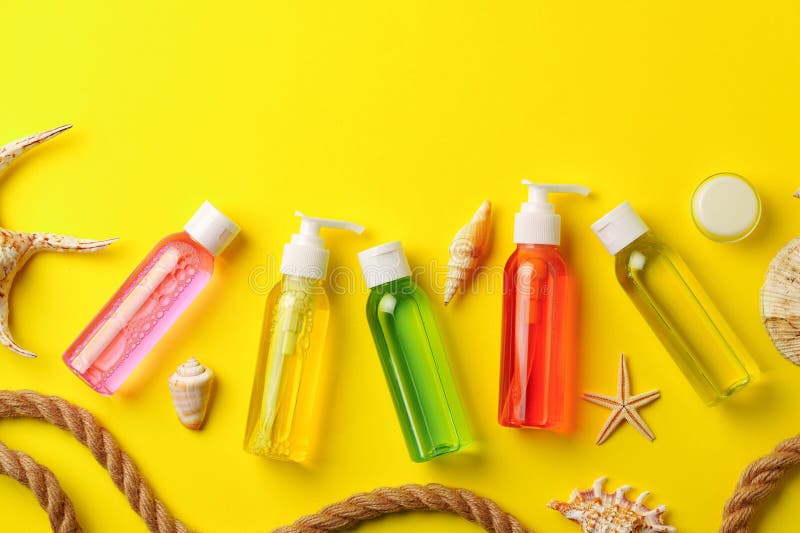 Colorful Bottles of Sunscreen with Seashells on Yellow Background Stock ...