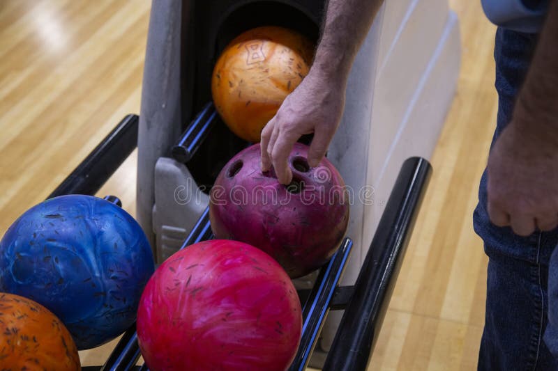 Colorful Bowling Ball in the Hands of a Man, Stock Photo - Image of ...