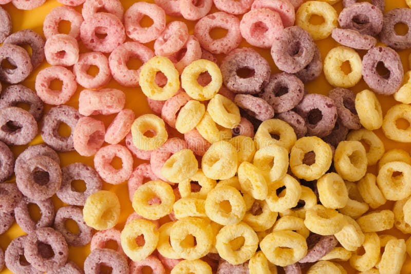 Colorful Breakfast Cereals on Yellow Background Top View, Rounded ...