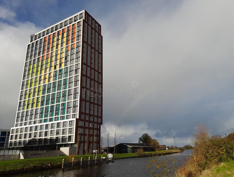 Colorful Building by Canal with a Small Rainbow Stock Photo - Image of ...