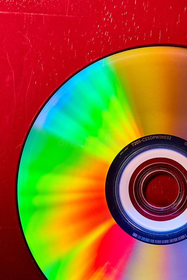 Colorful CD on Red Background with Bursts of Rainbow Colored Lights ...