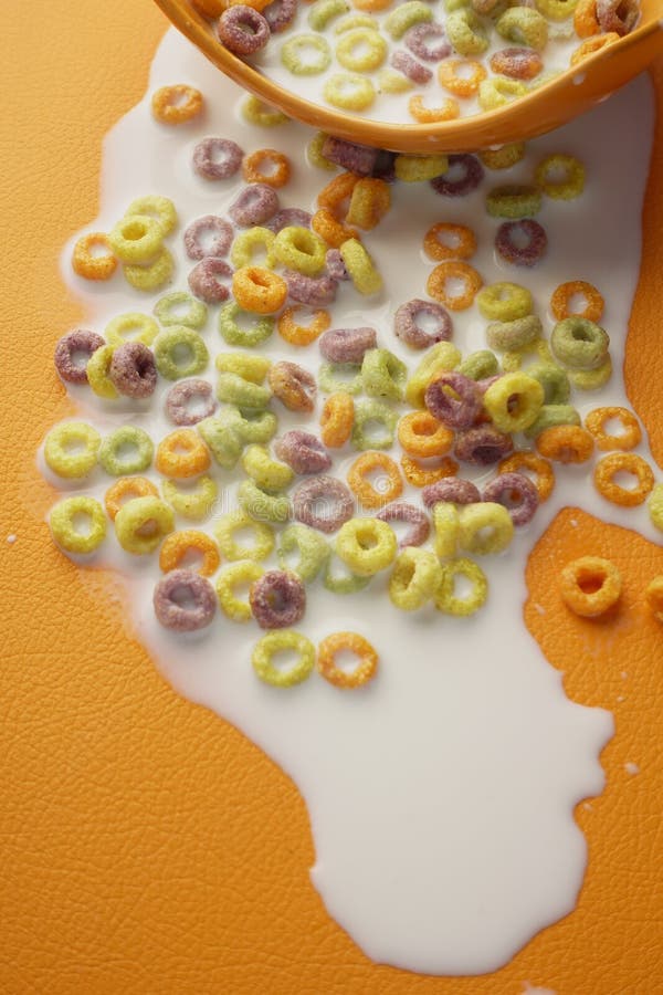 Colorful Cereal Spills Milk on an Orange Surface in the Kitchen Stock ...
