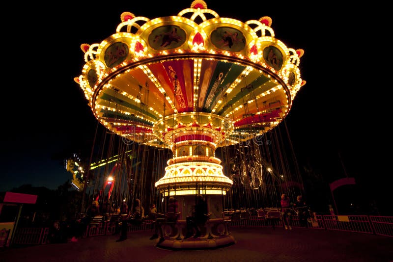 Colorful Chain Swing Carousel in Motion at Amusement Park at Night ...