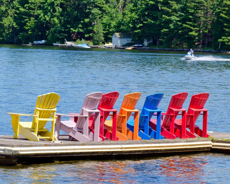 Colorful chairs on a dock stock photo. Image of wave - 26135790