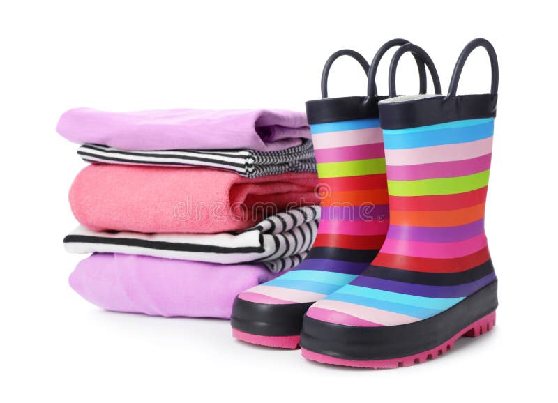 Colorful Children`s Rubber Boots and Stack of Clothes Stock Photo ...