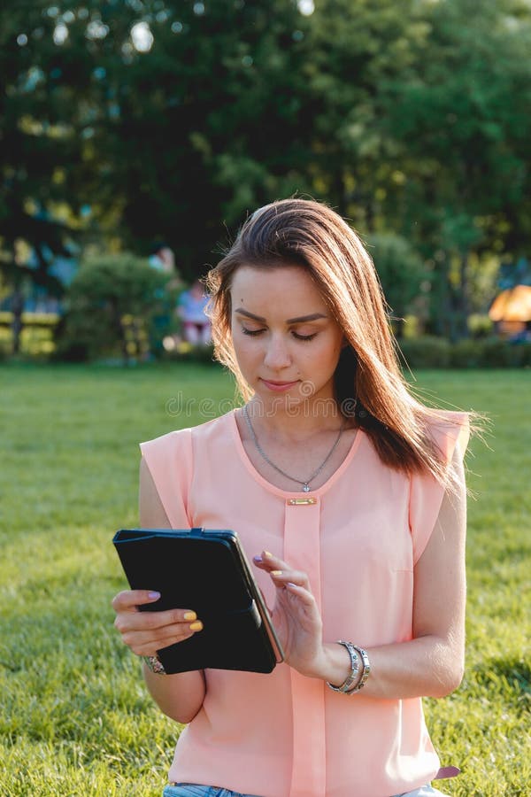 Colorful Close Up of Girl Using Tablet in the Park Stock Photo - Image ...
