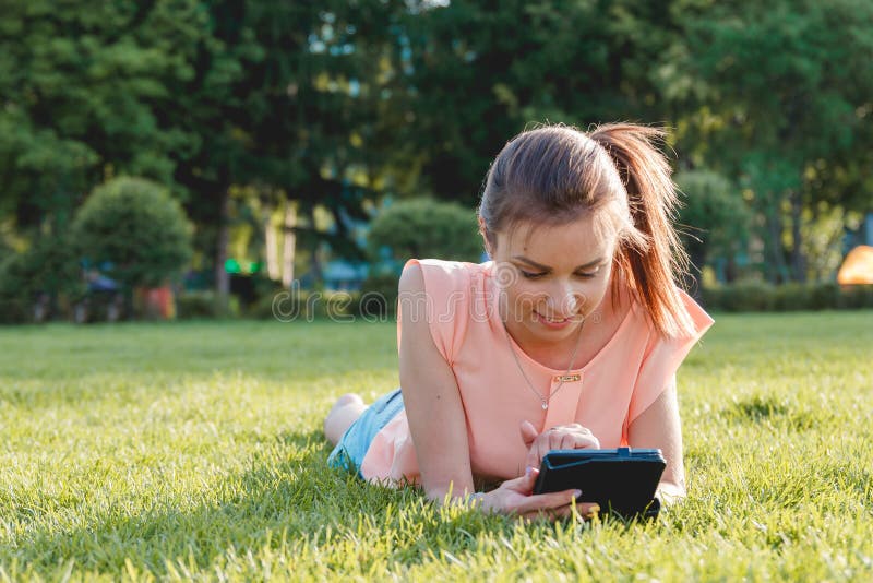 Colorful Close Up of Girl Using Tablet in the Park Stock Image - Image ...