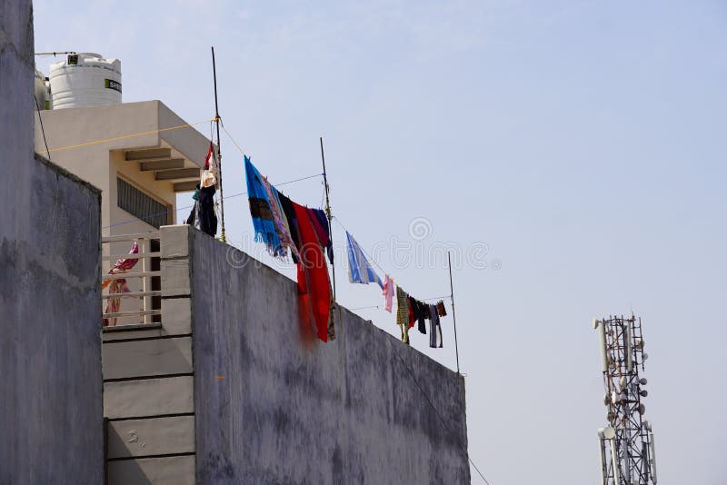 Colorful Clothes Drying on Clothesline on the Top Roof of Building ...