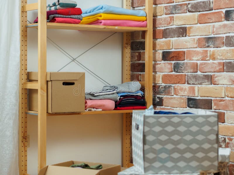 Clothes on Racks and in a Cardboard Box at Home Stock Image - Image of ...