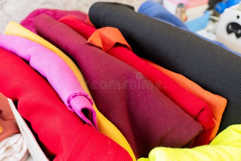 Colorful Collection of Folded Fabric Stacked in a Creative Workspace ...