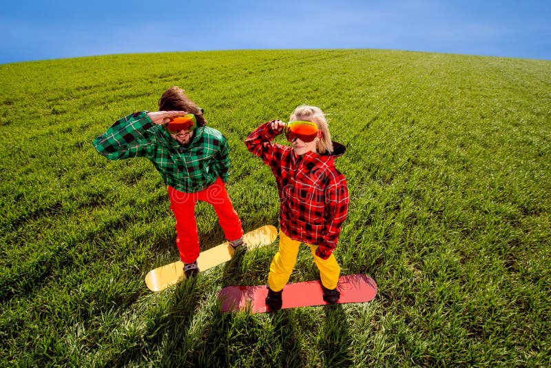 Colorful Couple Snowboarding on the Grass in Greenfield Stock Image ...