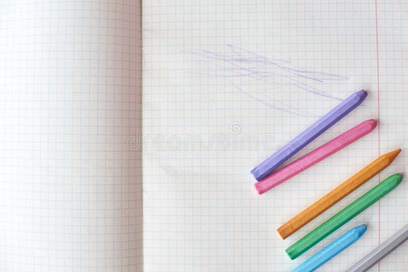 Colorful Crayons Lined Up on Opened Graph Paper Notebook with Abstract ...