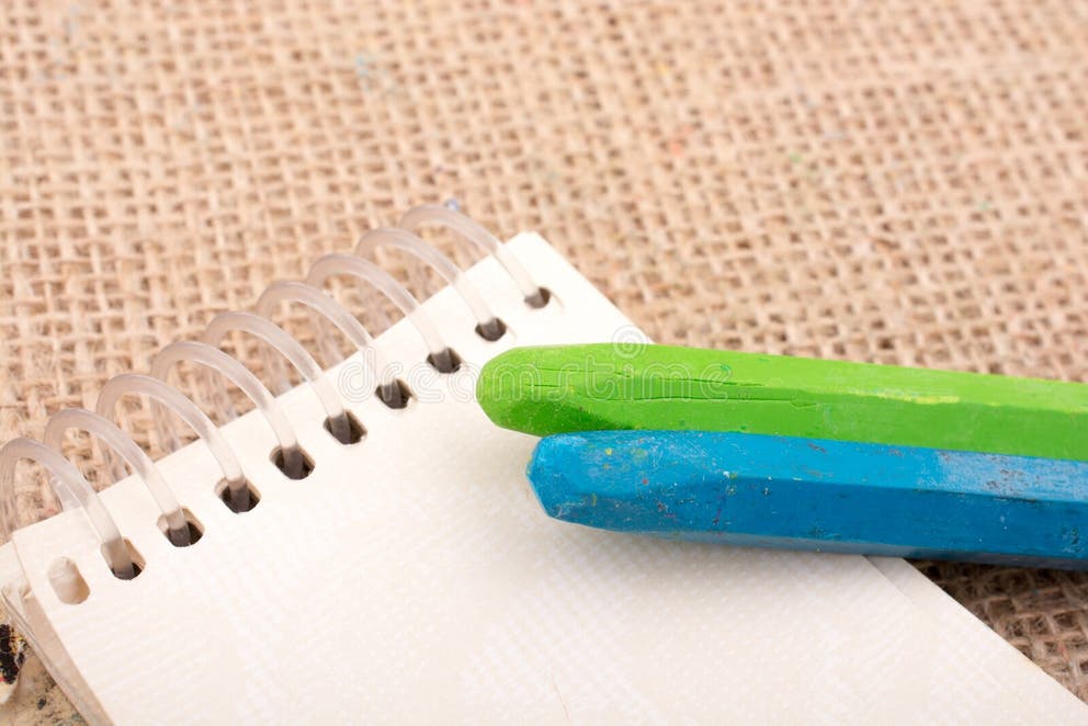 Colorful Crayons Placed on a Notebook Stock Photo - Image of canvas ...