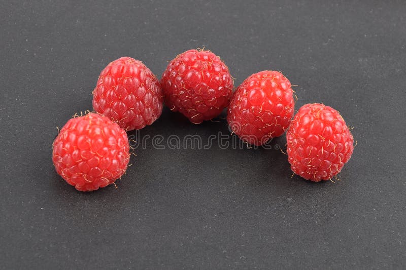 Red raspberries on black stock image. Image of raspberry - 107306351