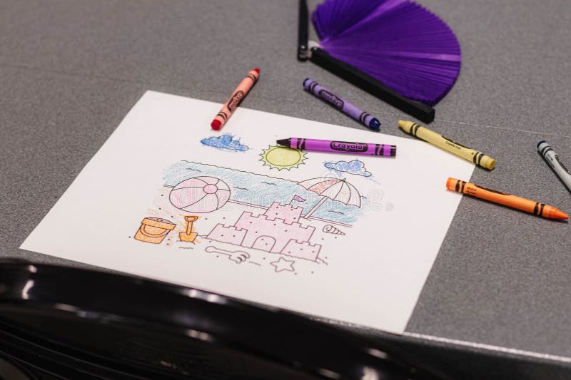 Colorful Drawing of a Beach Scene with Crayons Scattered on a Table ...