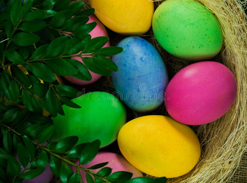 Colorful Easter Eggs on Hay in the Wicker Basket Stock Photo - Image of ...