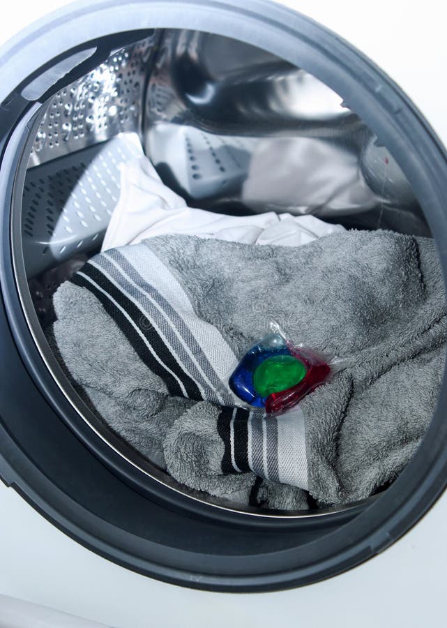 A Colorful Eco Washing Gel in Capsule in a Washing Machine with Laundry ...