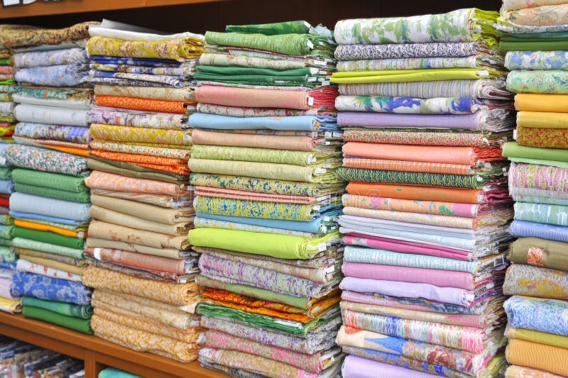 Colorful Fabric Rolls Stacked on Shelves in a Textile Store - Patterned ...