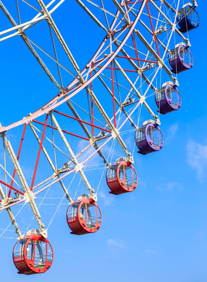 Ferris Wheel with Colorful Baskets on Blue Sky Background Stock Photo ...