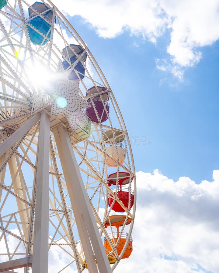 Colorful Ferris Wheel on a Shiny Day with Some Clouds in the Background ...