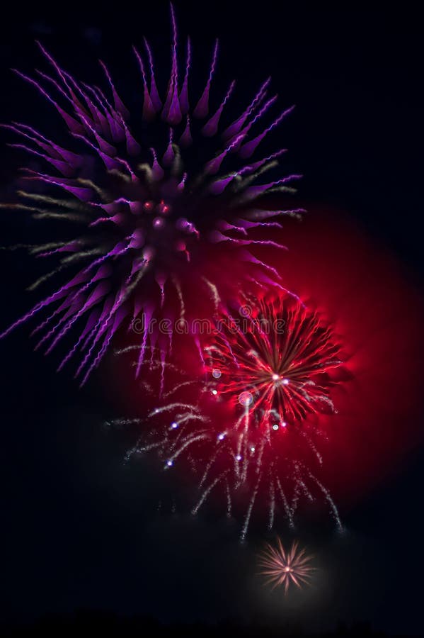Colorful Fireworks Exploding in the Night Sky with Vibrant Red and ...
