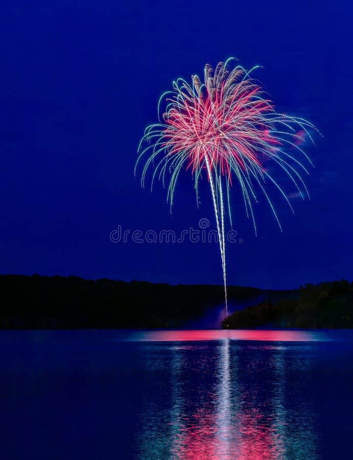 Fireworks Over Water with Reflections on Water Surface Stock Photo ...