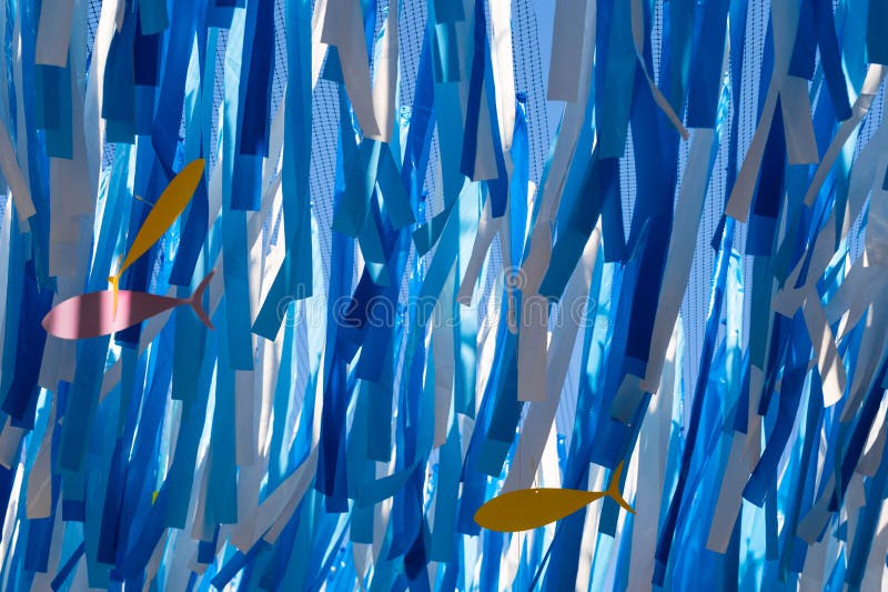 Colorful Fish Decorations Amid Blue and White Streamers Stock Image ...