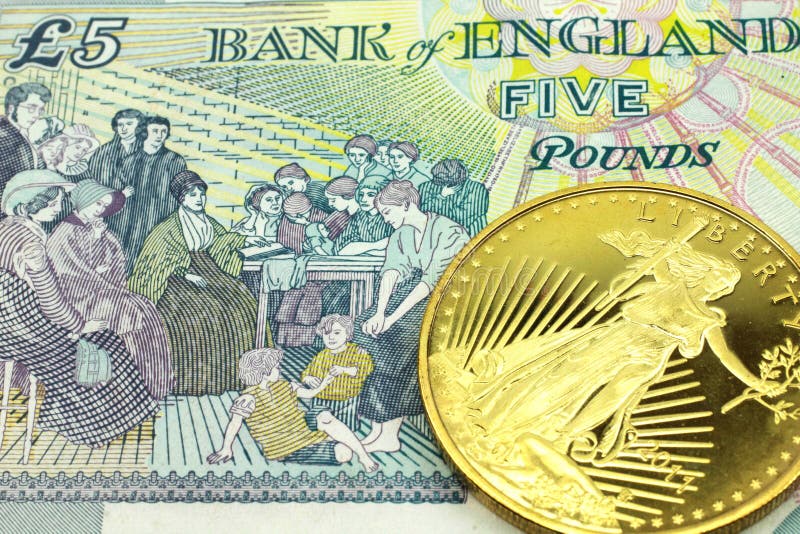 A Colorful Five Pound Note from the UK with a Gold Coin in Macro ...