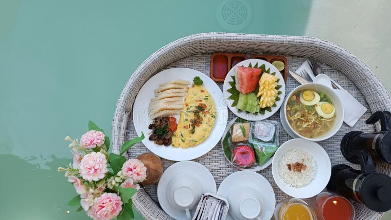 Colorful Floating Breakfast Spread with Exotic Dishes by Pool Stock ...